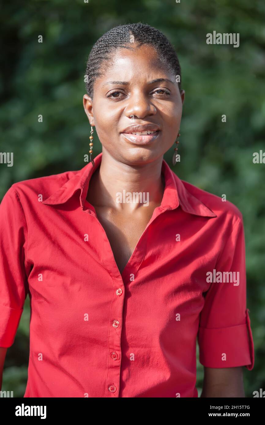 Young African Motswana woman, standing in the garden green vegetation ...