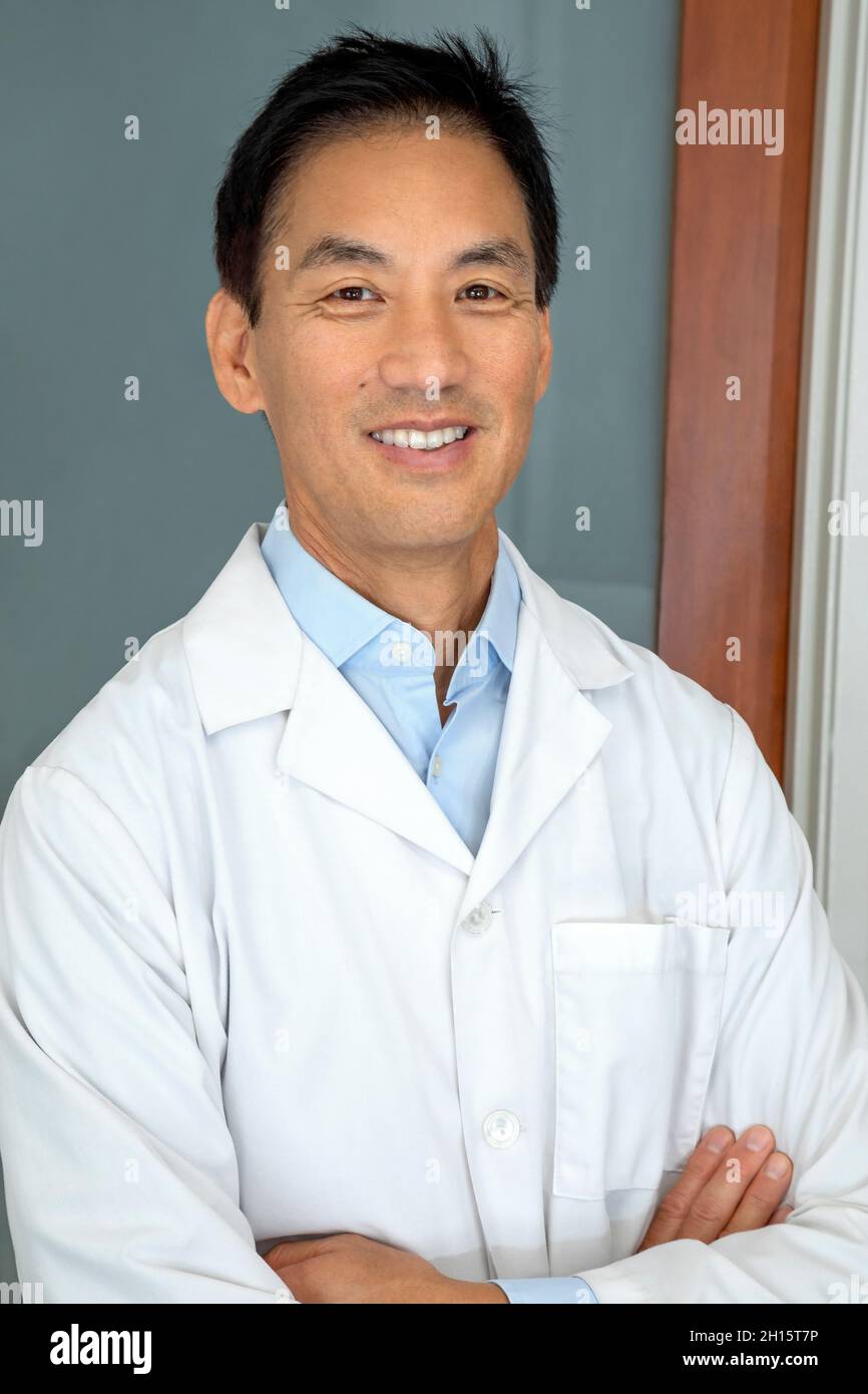 Asian male doctor inside his office Stock Photo - Alamy