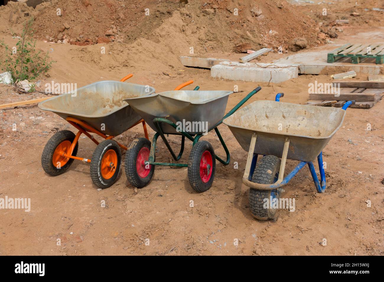 Construction wheelbarrows. Three wheelbarrows without people on the ...