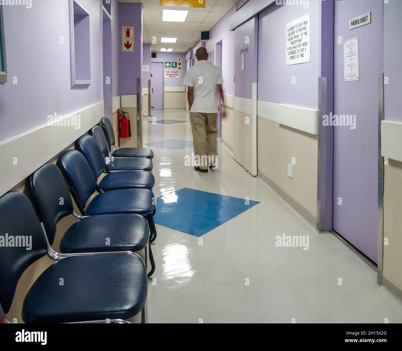 Generic hospital hallway, African doctor walking Stock Photo - Alamy