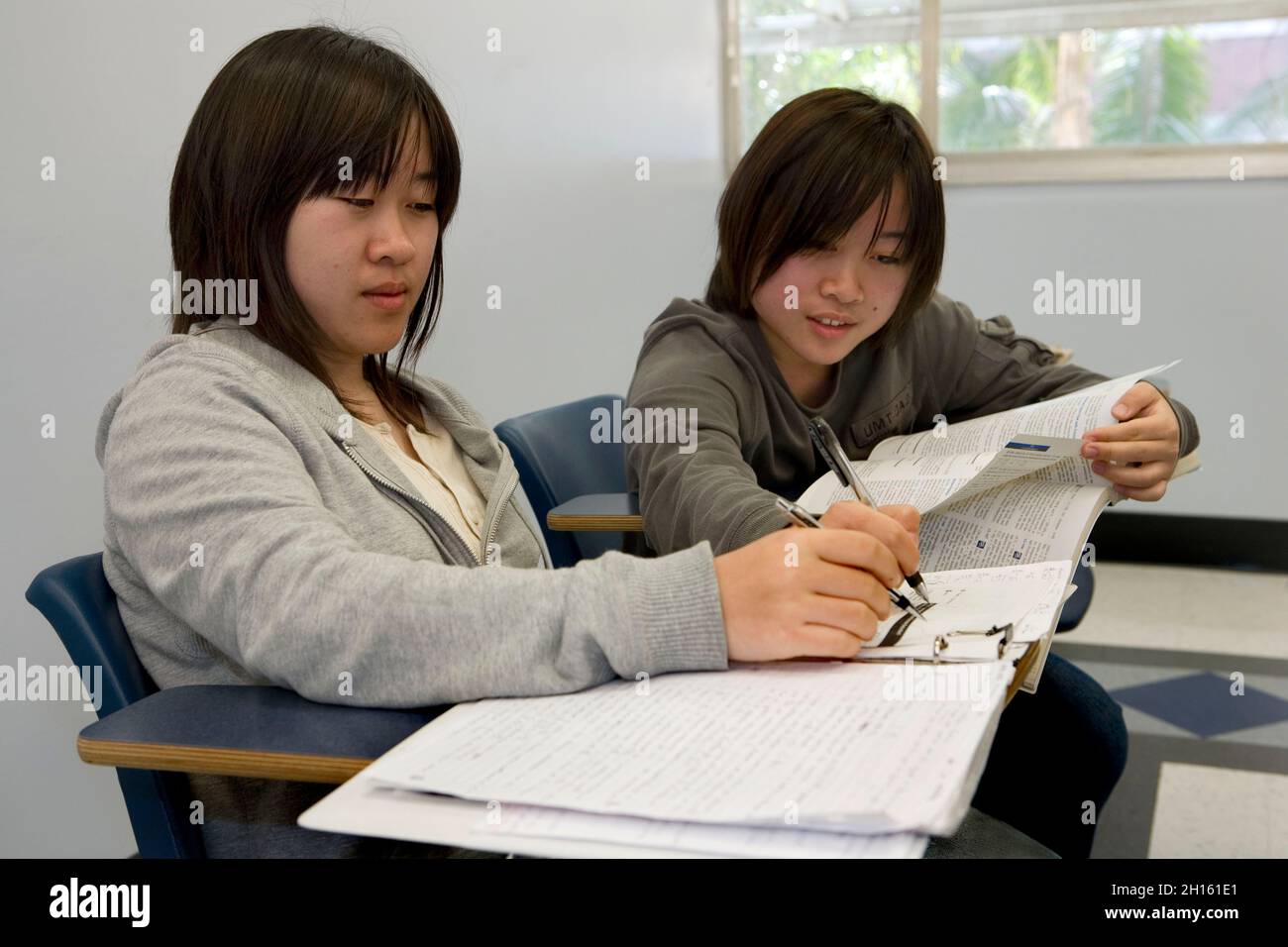 Chinese students do homework in class MR - Model Released Stock Photo ...