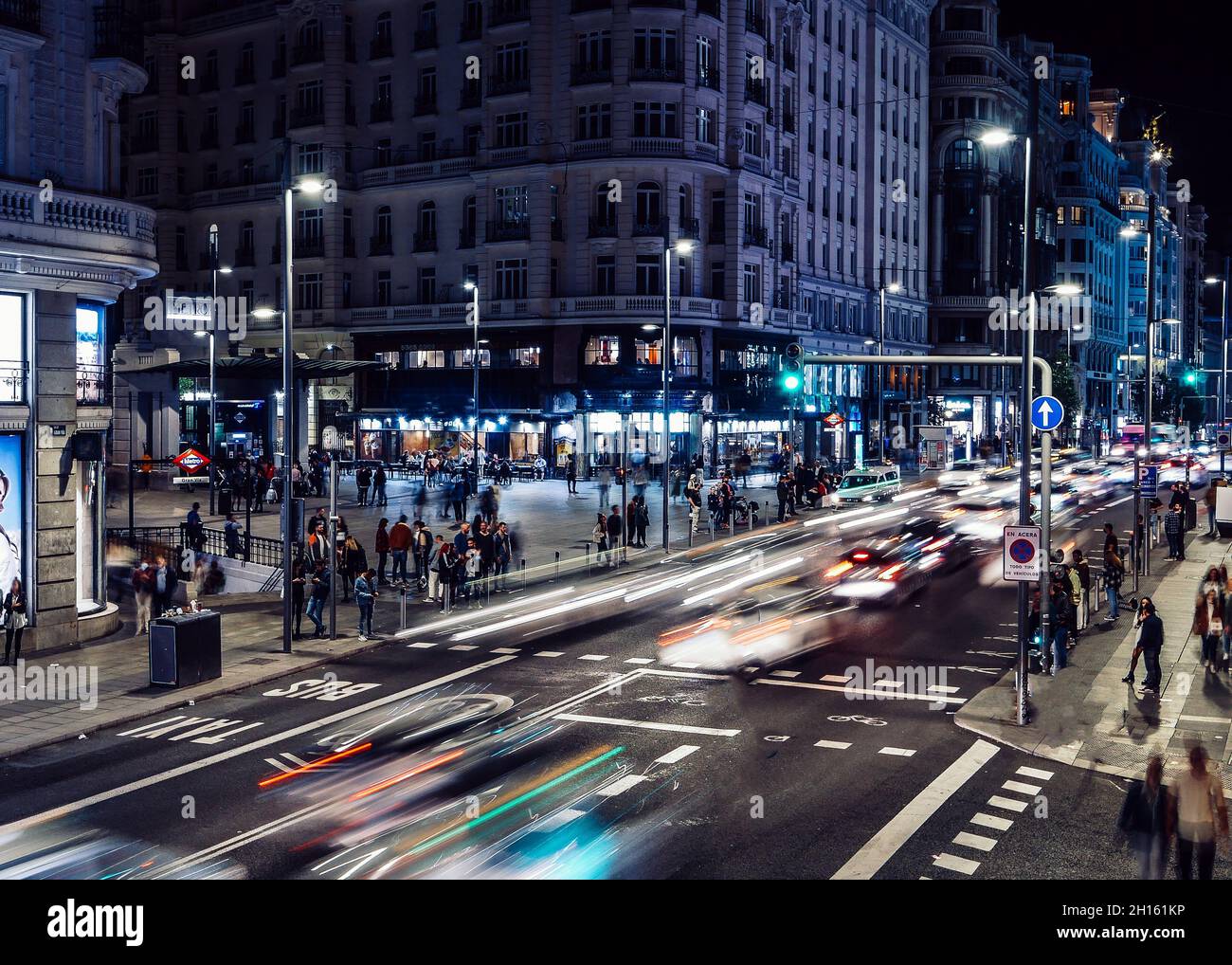 High perspective night time lapse view of busy pedestrian and vehicle ...