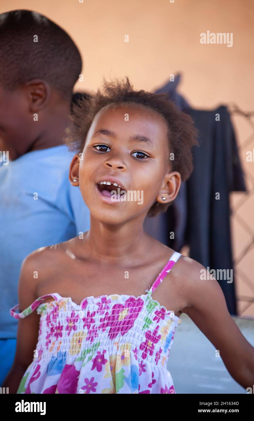 African child portrait in a village in the rural Botswana standing in ...