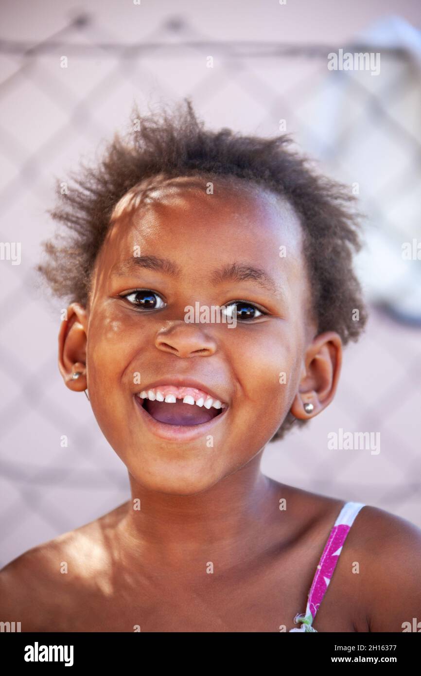 African child portrait in a village in the rural Botswana standing in ...