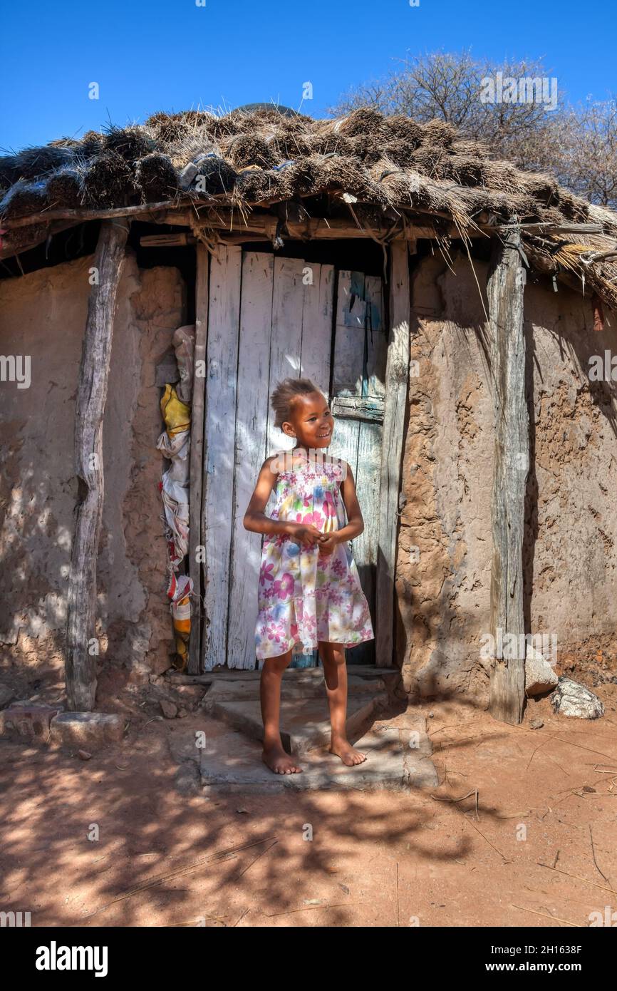 African child portrait in a village in the rural Botswana standing in ...