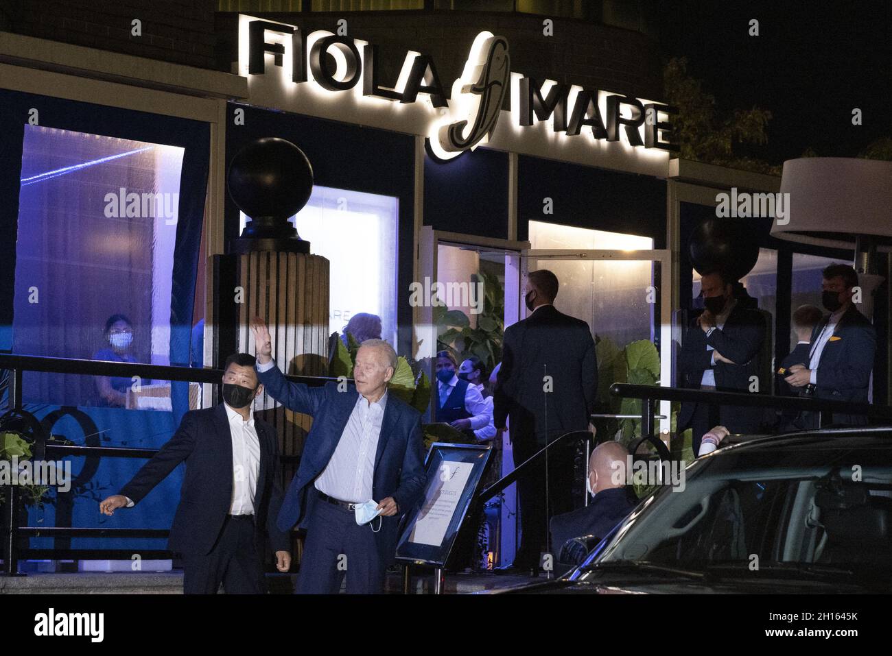 US President Joe Biden greets onlookers, as he walks outside Fiola Mare ...