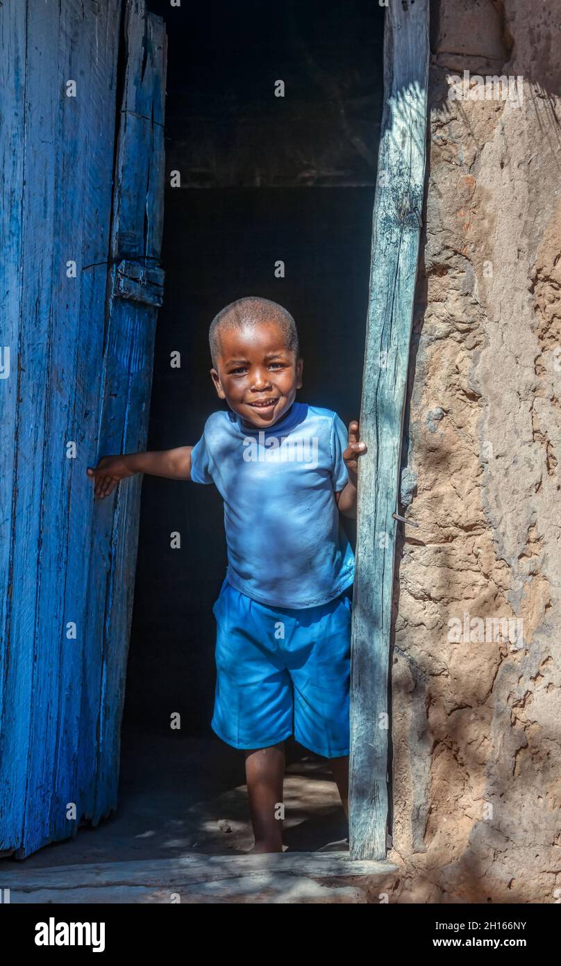 African child portrait in a village in the rural Botswana standing in ...