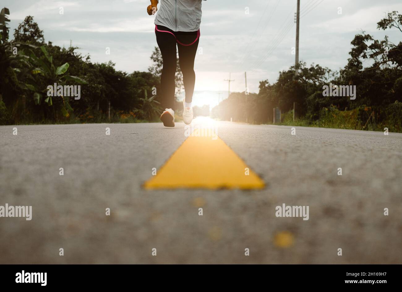 Female runners running on the road trail in morning training for ...