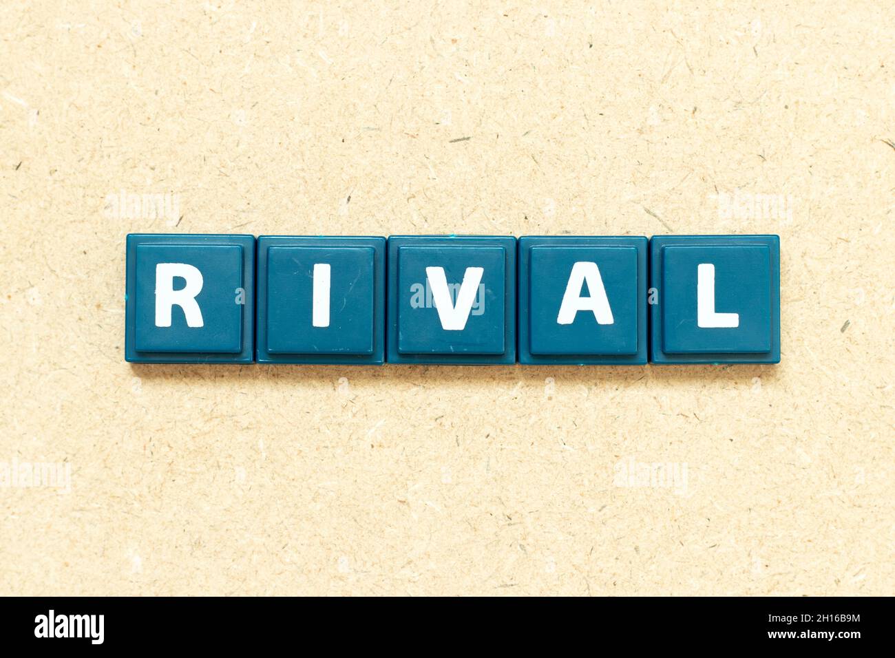 Tile alphabet letter in word rival on wood background Stock Photo - Alamy