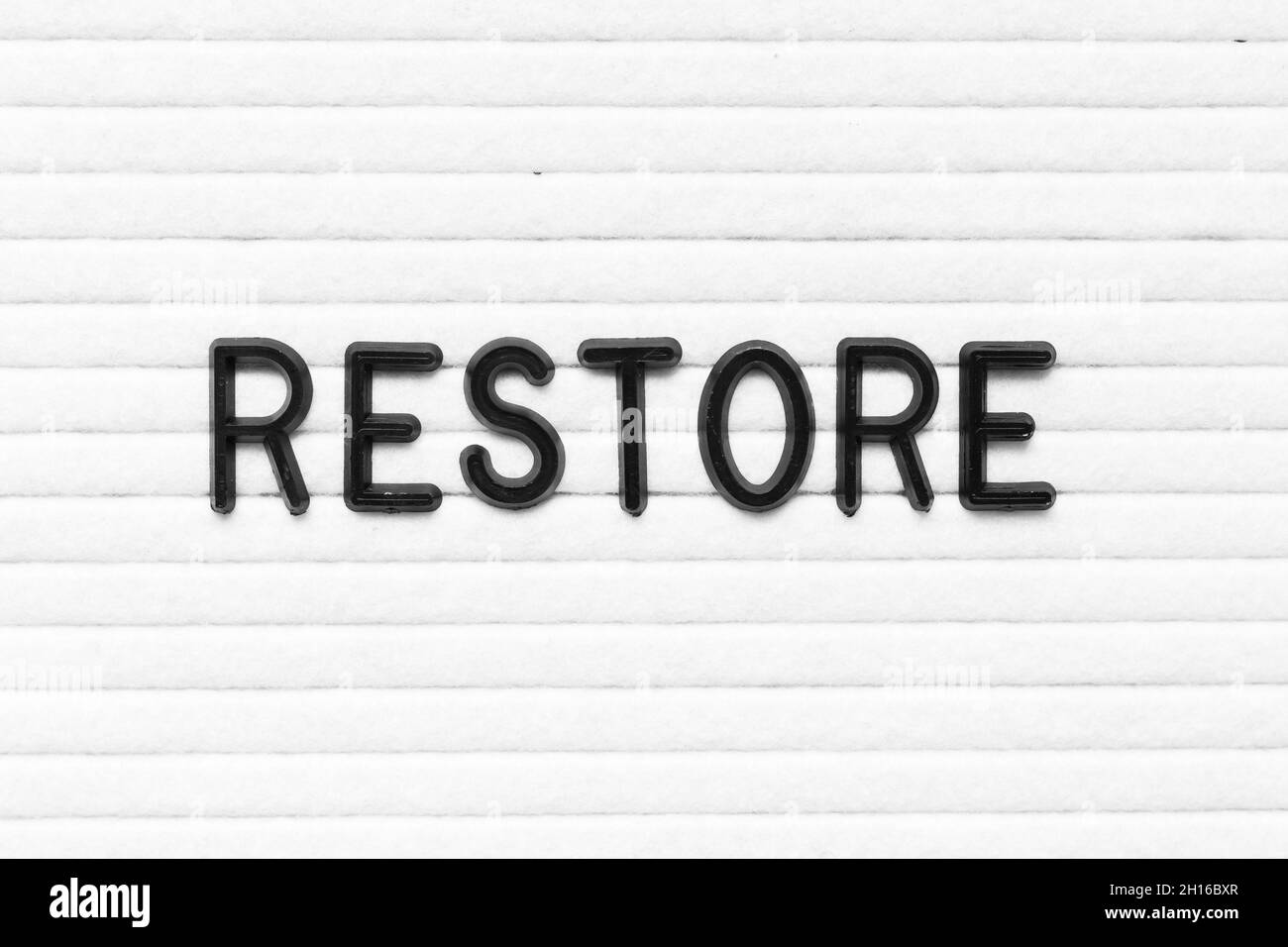 Black Letter In Word Restore On White Felt Board Background Stock Photo black-letter-in-word-restore-on-white-felt-board-background-stock-photo