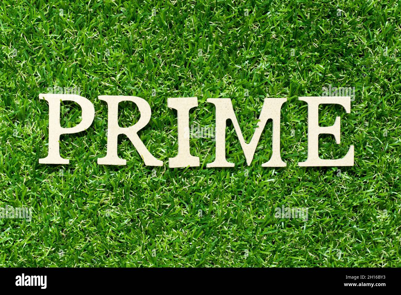 Wood letter in word prime on green grass background Stock Photo - Alamy