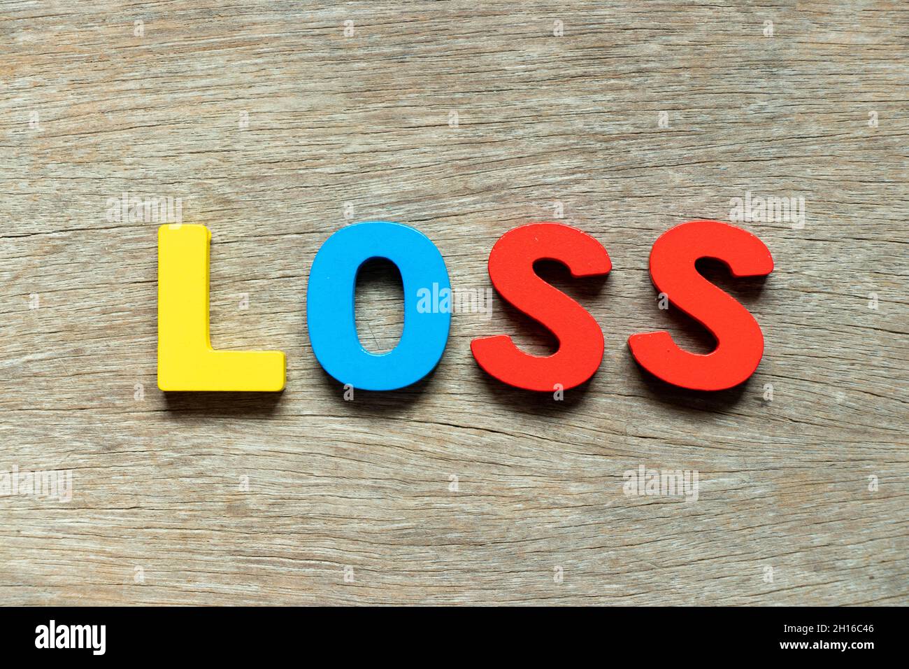 Color alphabet letter in word loss on wood background Stock Photo - Alamy