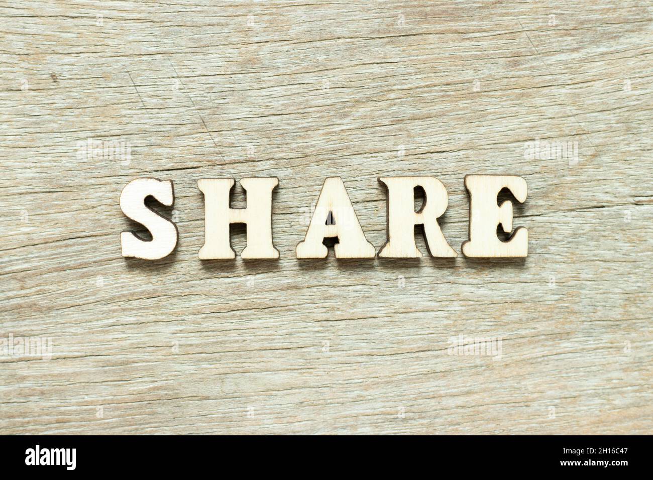 Alphabet letter in word share on wood background Stock Photo - Alamy