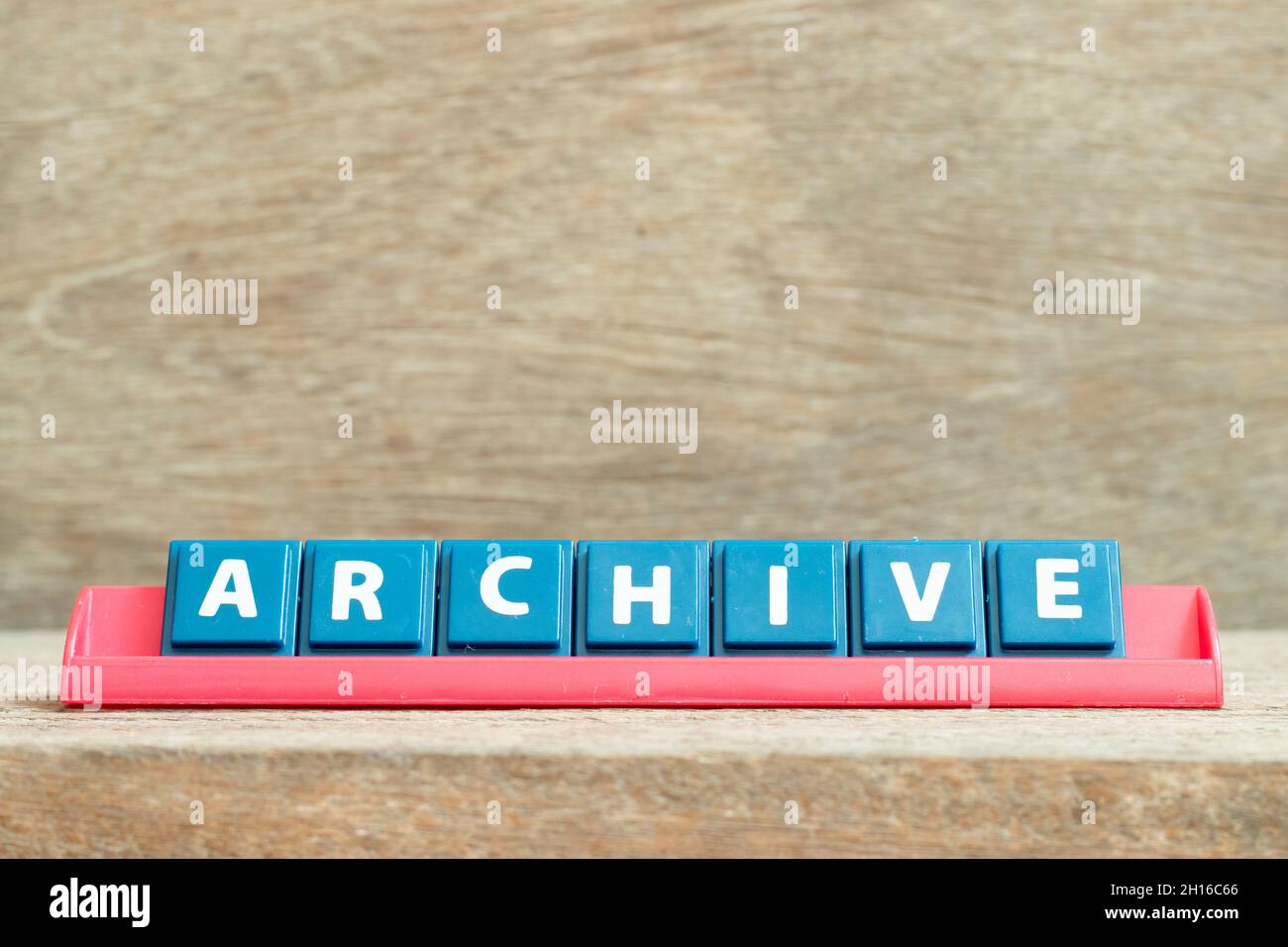 Tile alphabet letter with word archive in red color rack on wood ...