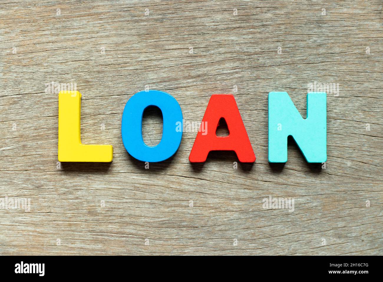 Color alphabet letter in word loan on wood background Stock Photo - Alamy
