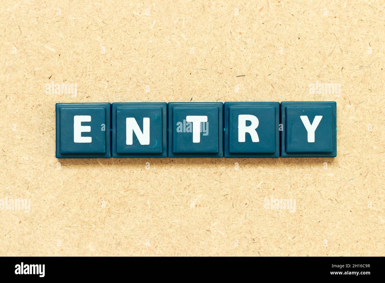 Tile alphabet letter in word entry on wood background Stock Photo - Alamy