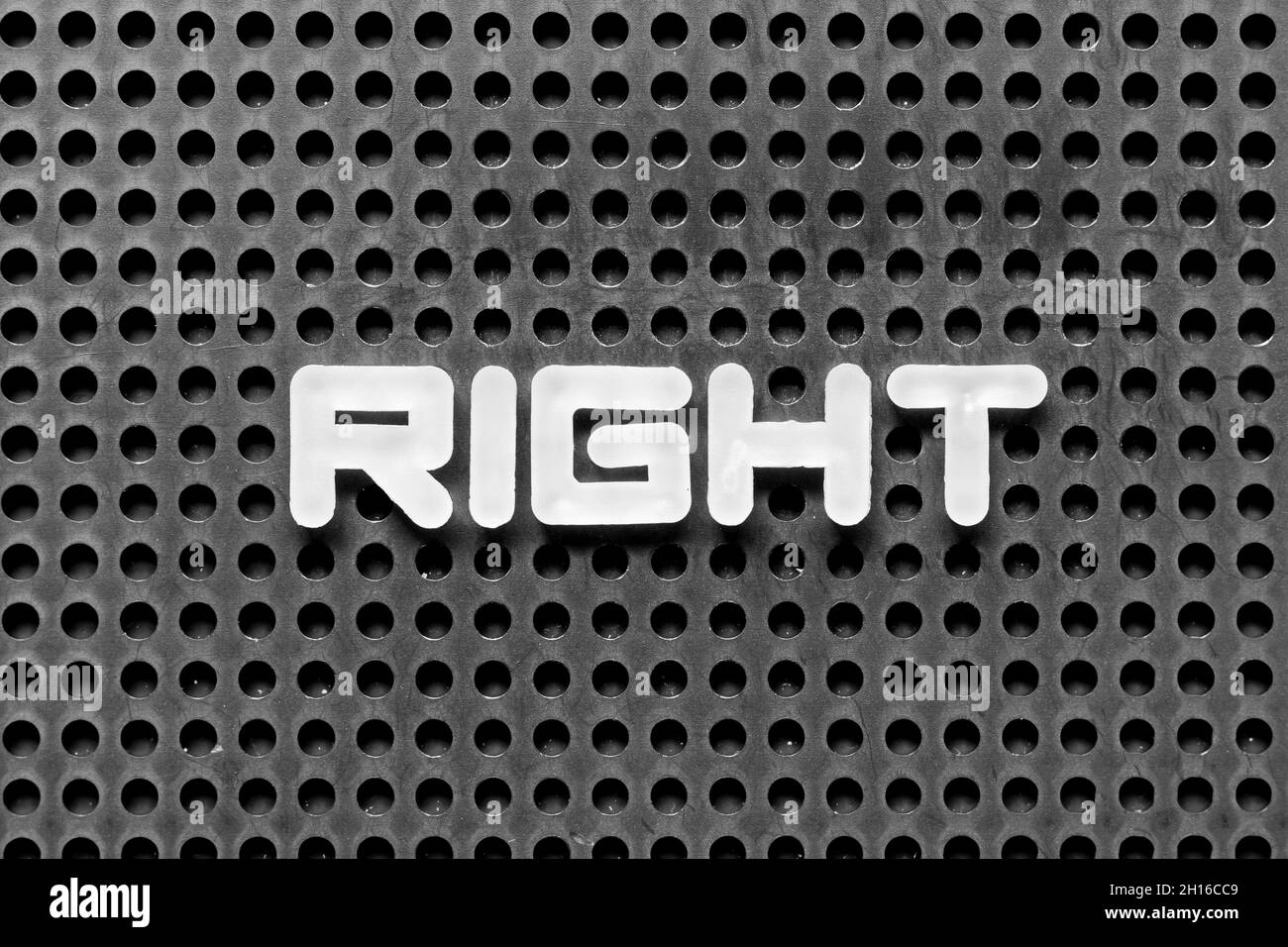 White alphabet letter in word right on black pegboard background Stock ...