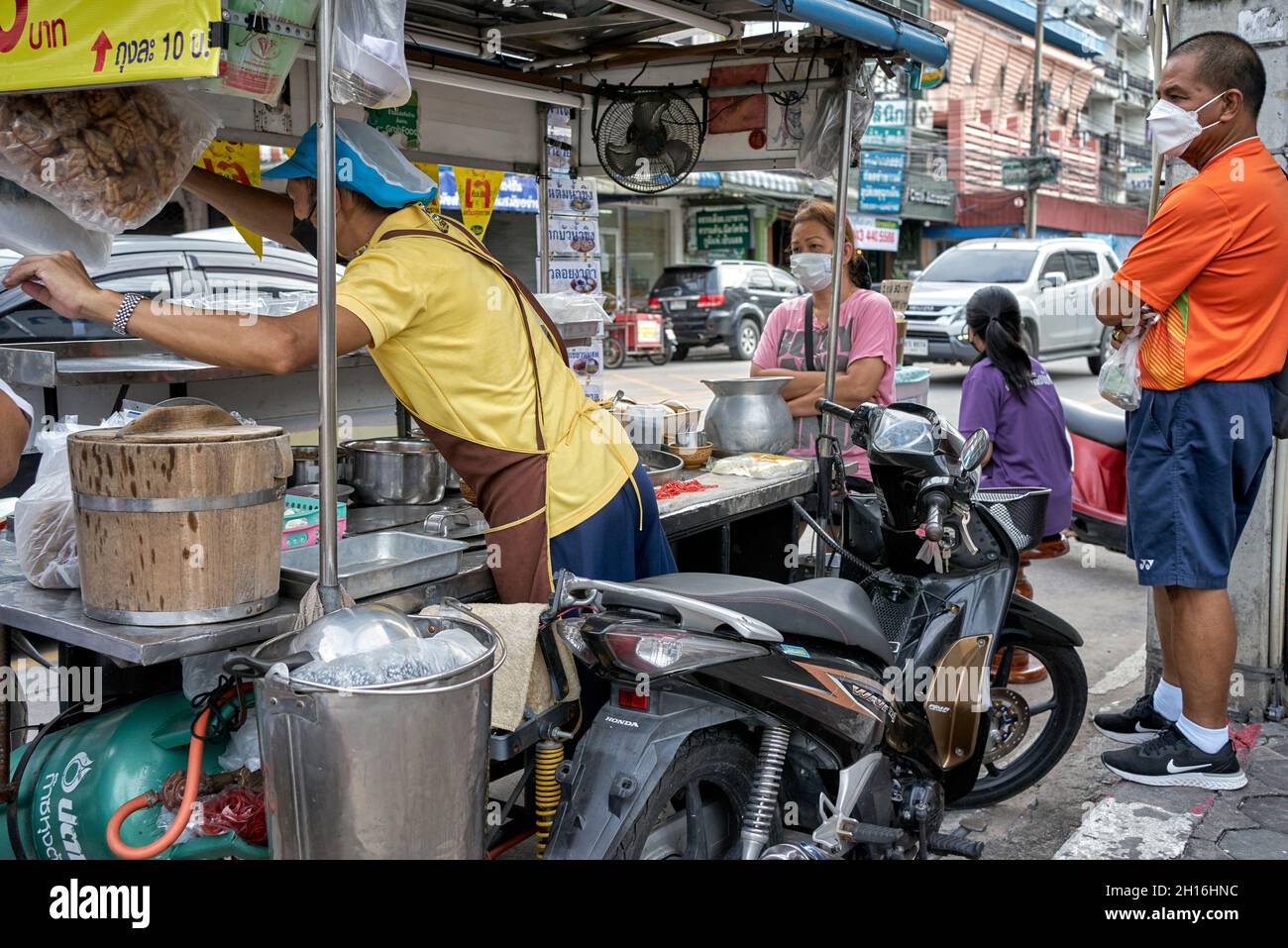 Thailand street food vendor selling from a motorcycle mounted stall ...