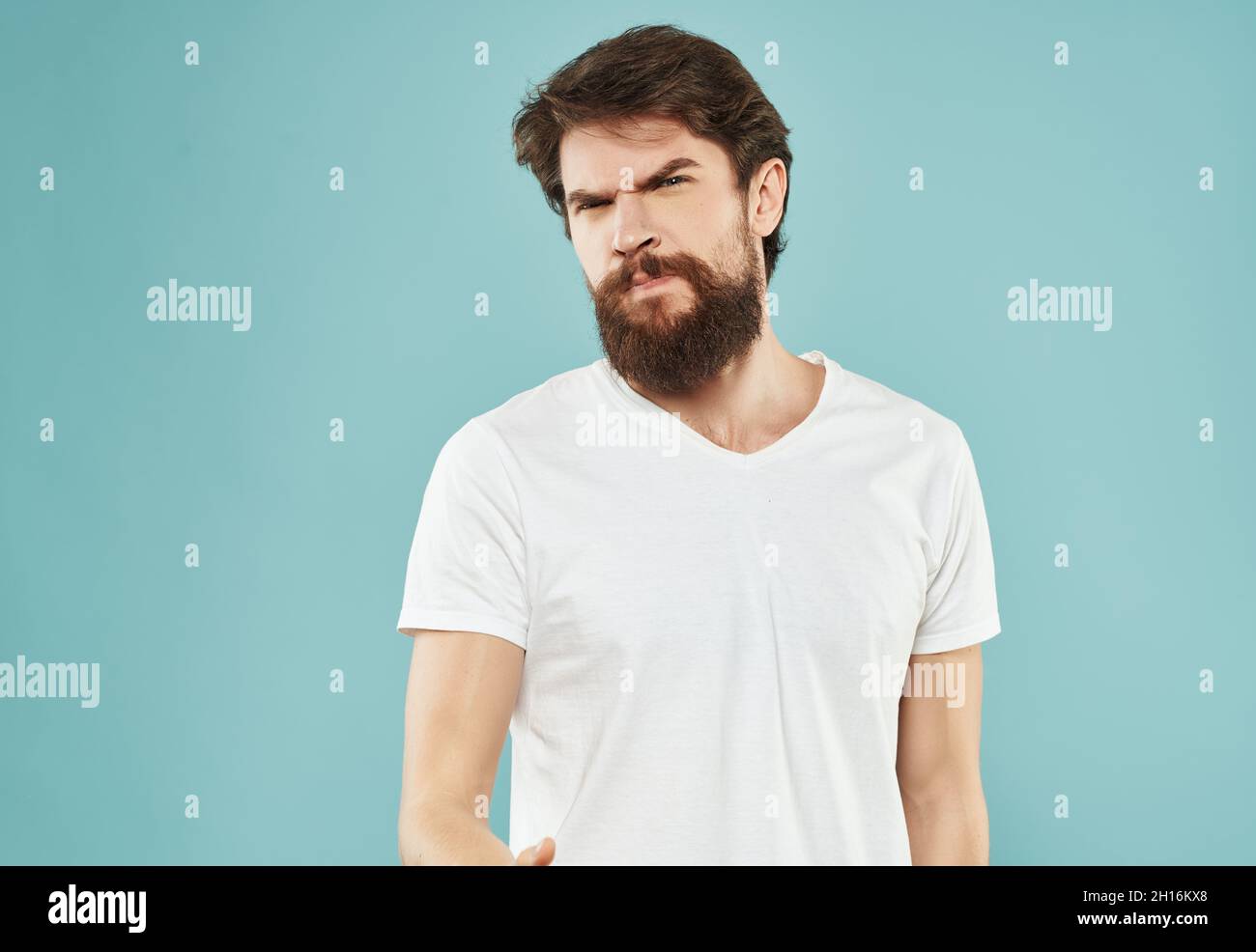 emotional man in a white t-shirt hand gestures anger Lifestyle Stock ...