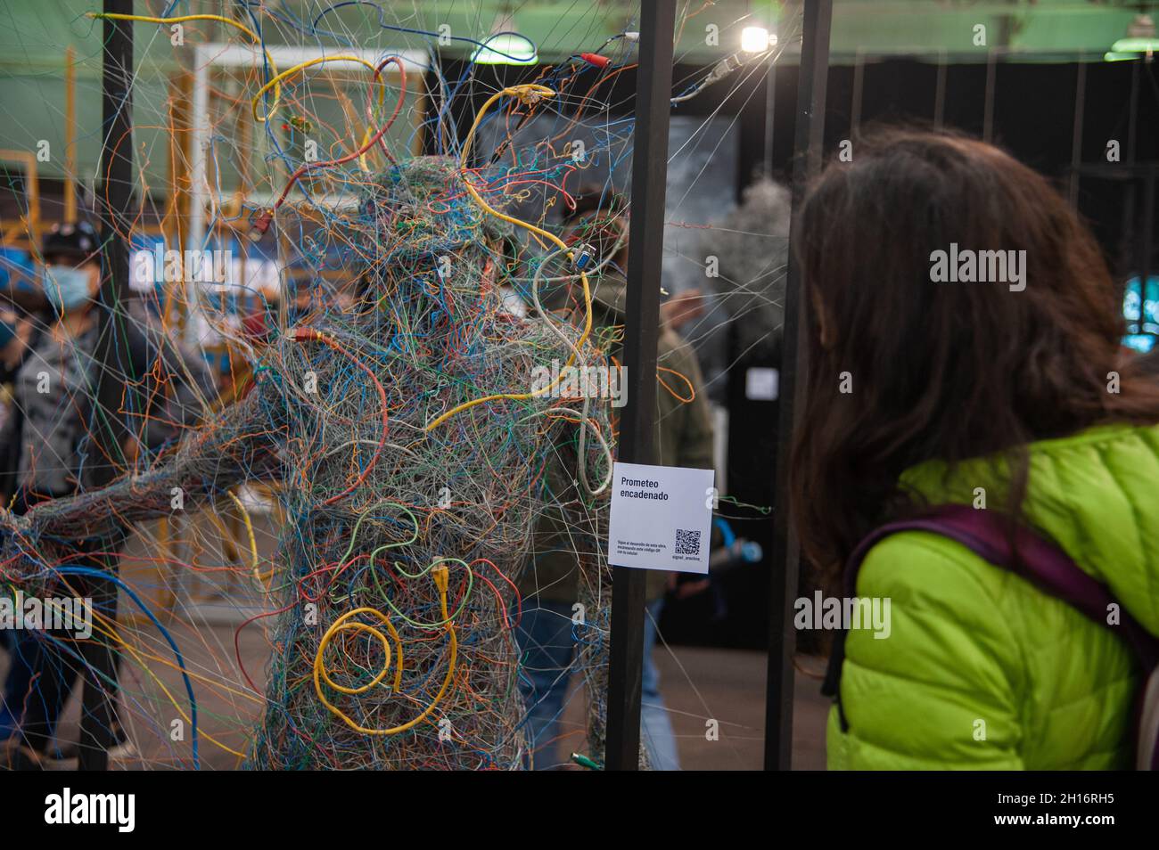 Attendees take a look to a sculture made out of computer wiring during ...