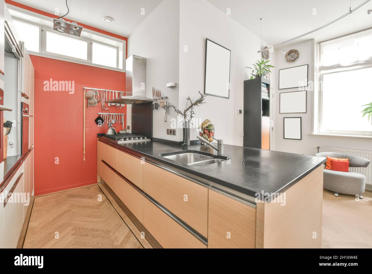 Island counter with undermounted sink in stylish kitchen with chrome ...