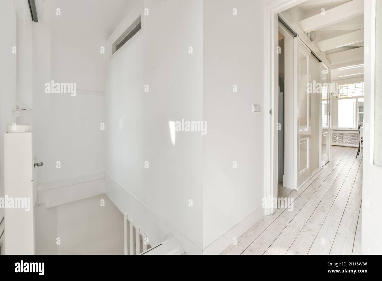 Minimalist interior of contemporary white hallway with staircase and ...