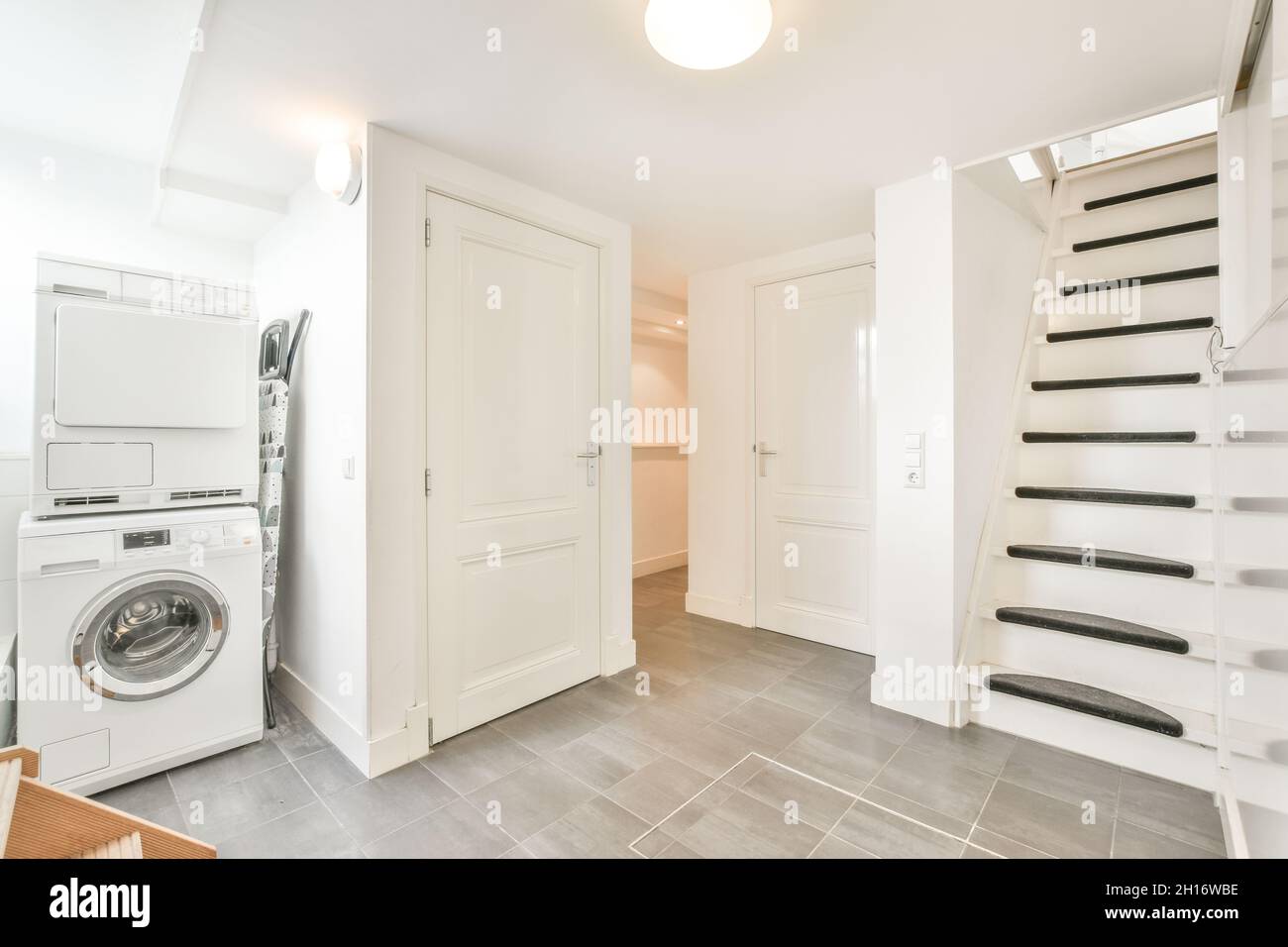 Modern interior design of contemporary laundry room with washing ...