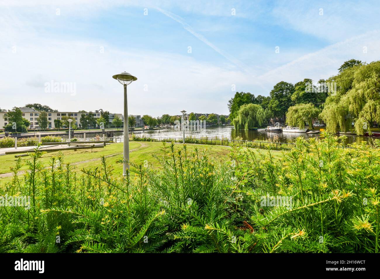 Peaceful empty promenade of calm rippling river flowing through city ...