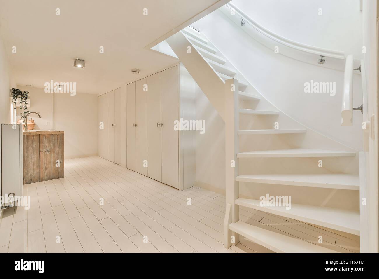 Creative design of wavy staircase against washstand and closets on ...