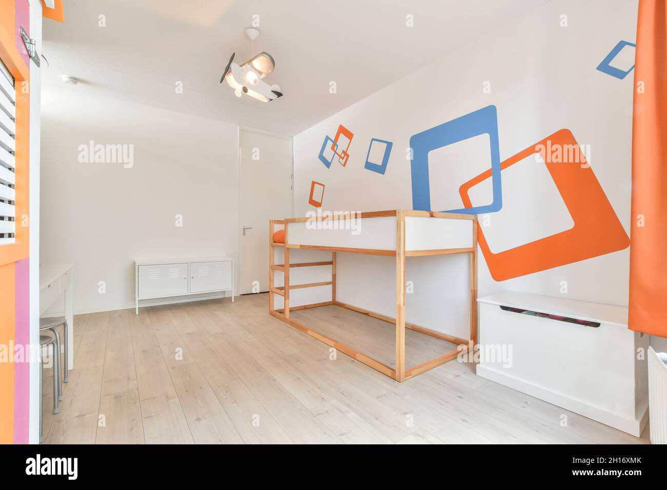 Modern bedroom interior with bunk bed between table and ornament on ...