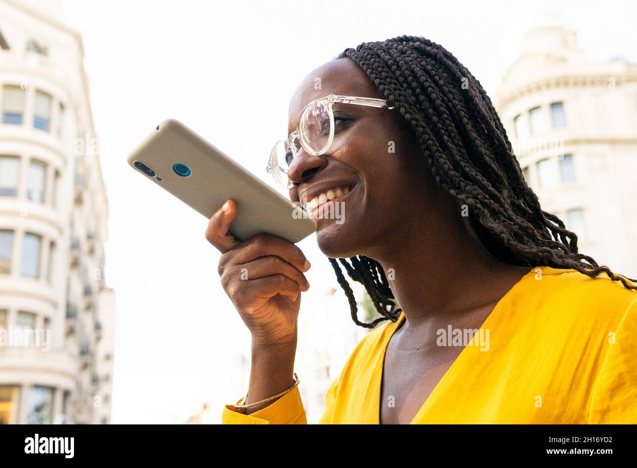 Slim female athlete bending aside with raised arm while sitting on ...
