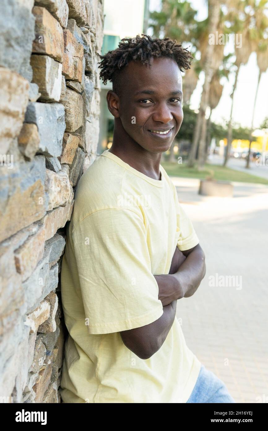 Positive African American young male with toothy smile wearing casual ...