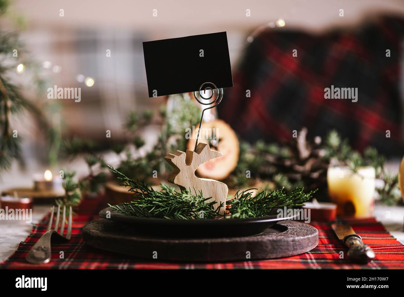Christmas table setting with reindeer of wood with blank name card on ...