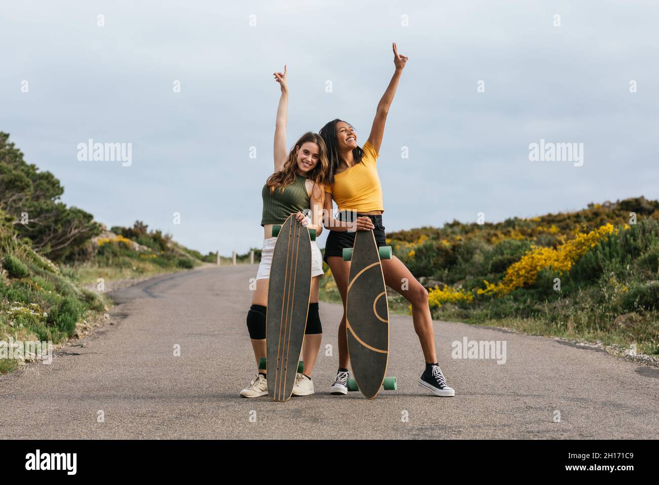 Full body of happy multiethnic girlfriends with outstretch arms ...