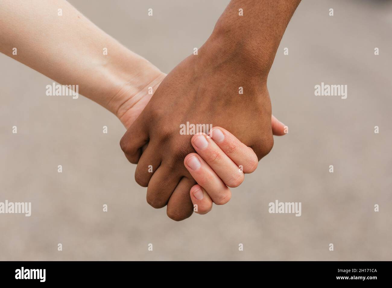 Crop anonymous multiethnic friends holding hands for unity friendship ...