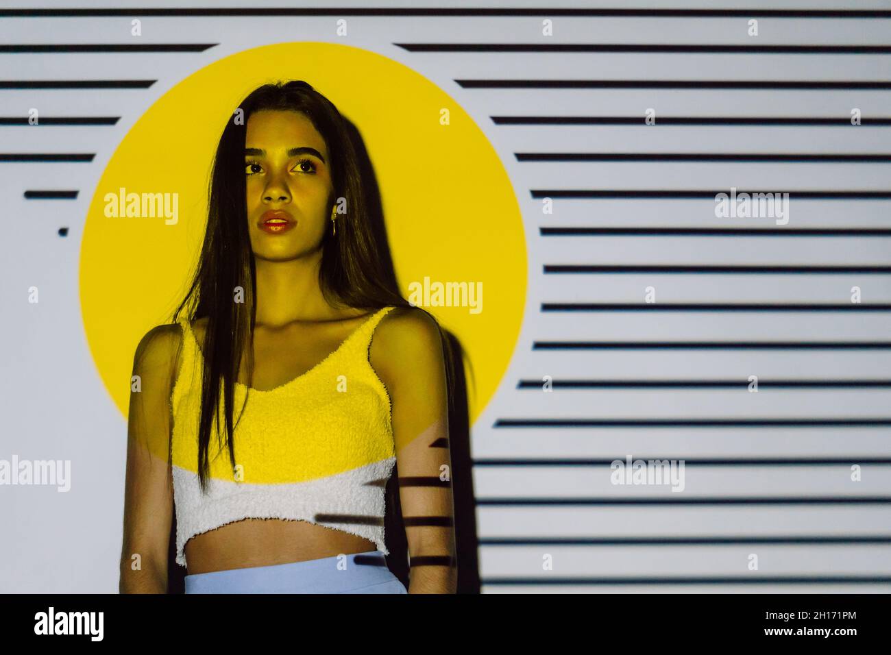Contemplative young Hispanic Woman with makeup and long hair looking ...