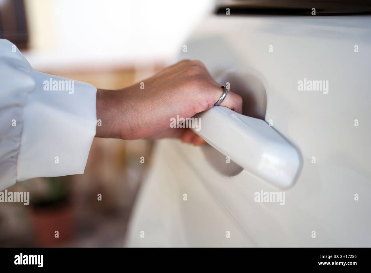 Side view of crop anonymous female passenger opening door of modern ...