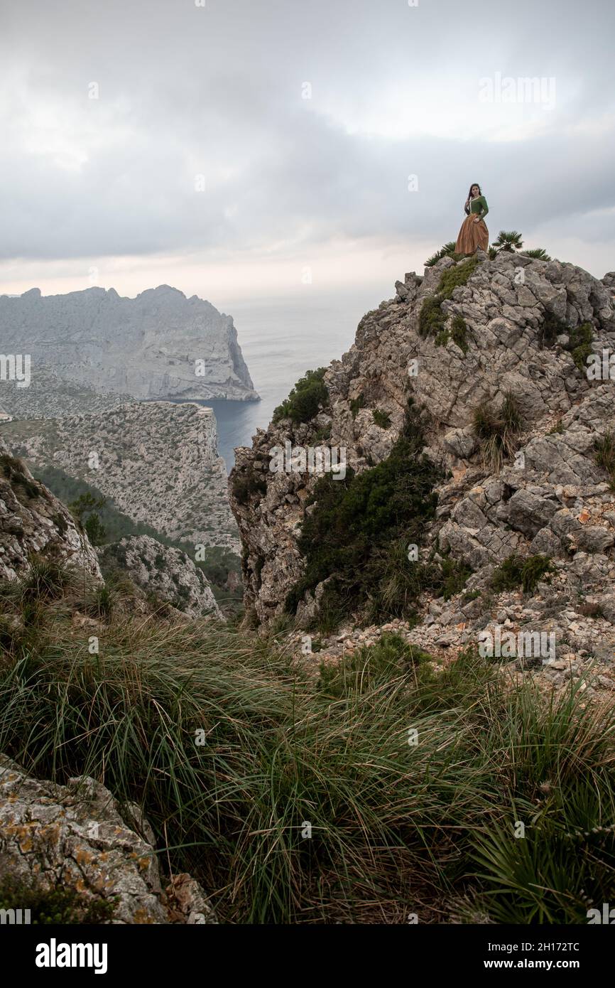 Woman standing stony cliff edge hi-res stock photography and images - Alamy