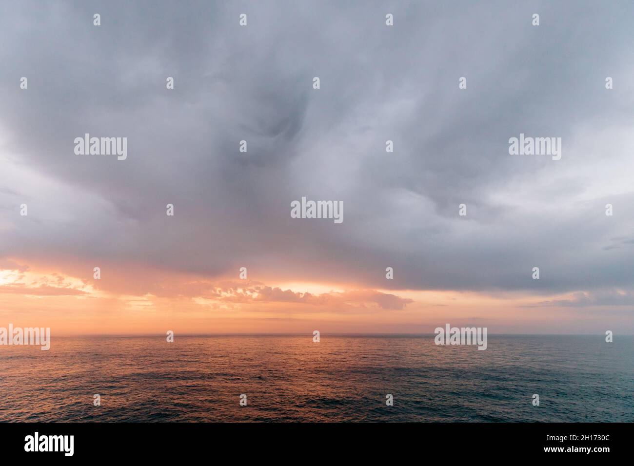 Endless rippling sea in coastal area against colorful cloudy sky and ...
