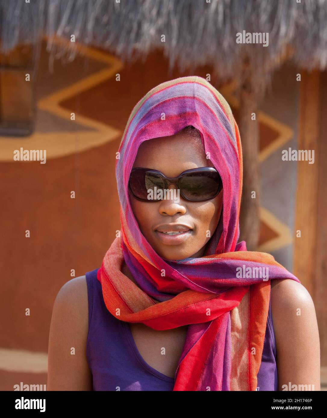 Muslim African woman in front of a traditional African house Stock ...