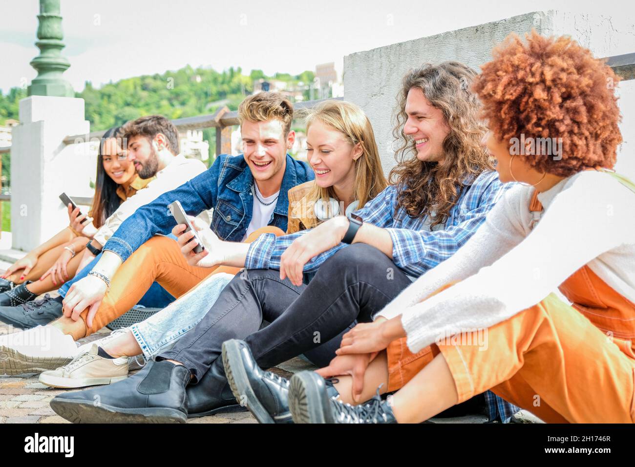 Multicultural group of friends using mobile phones - Students sitting ...