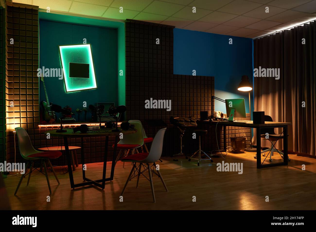 Interior of dark studio for podcast recording with modern computer and ...