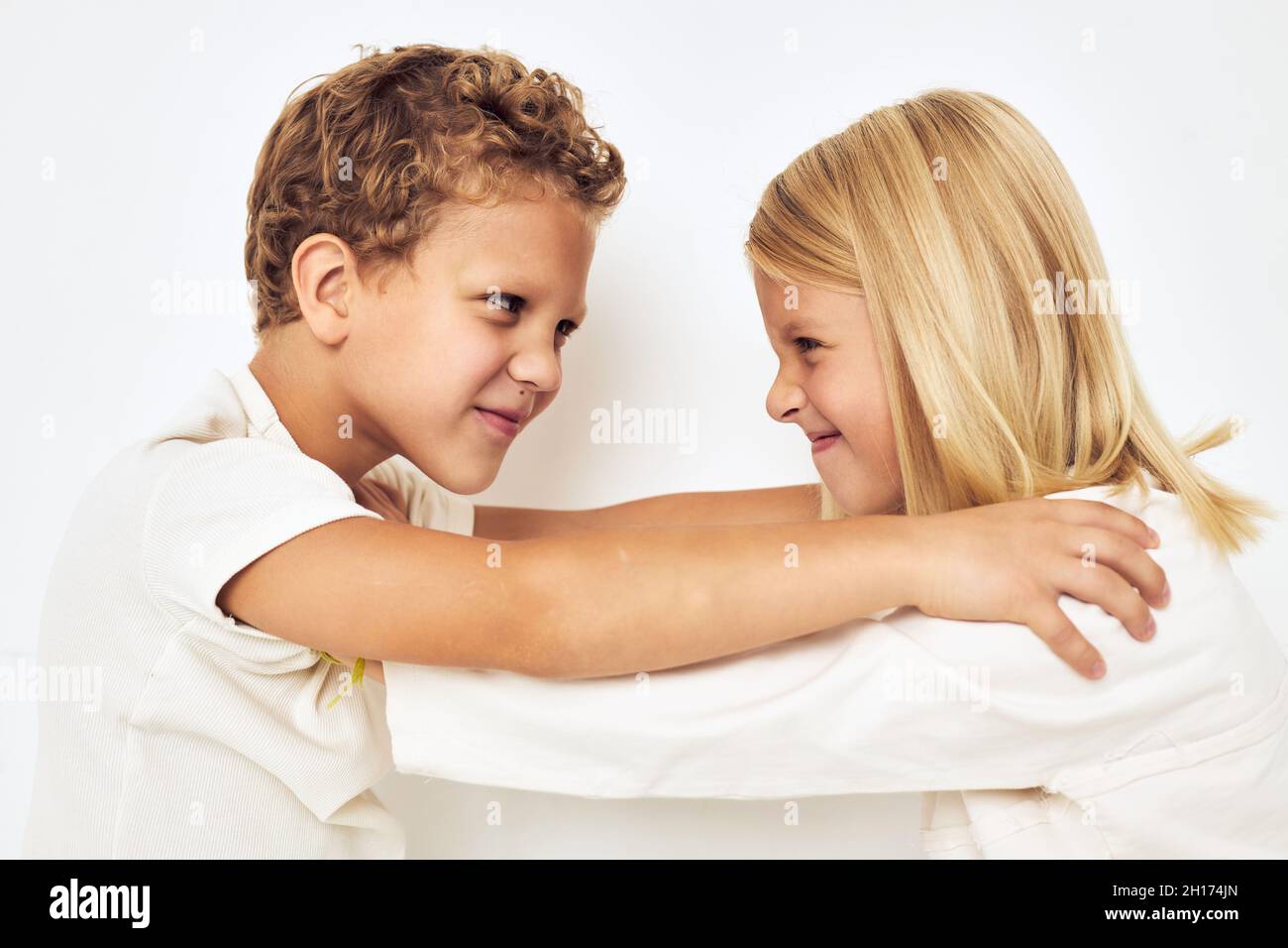 Bad brother sticks to sister smile posing casual wear light background ...