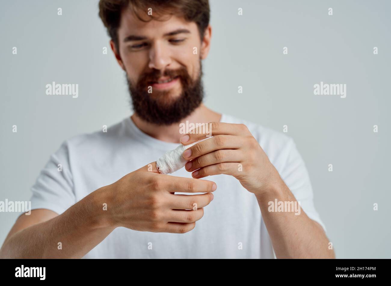 male patient bandaged hand injury to fingers isolated background Stock ...