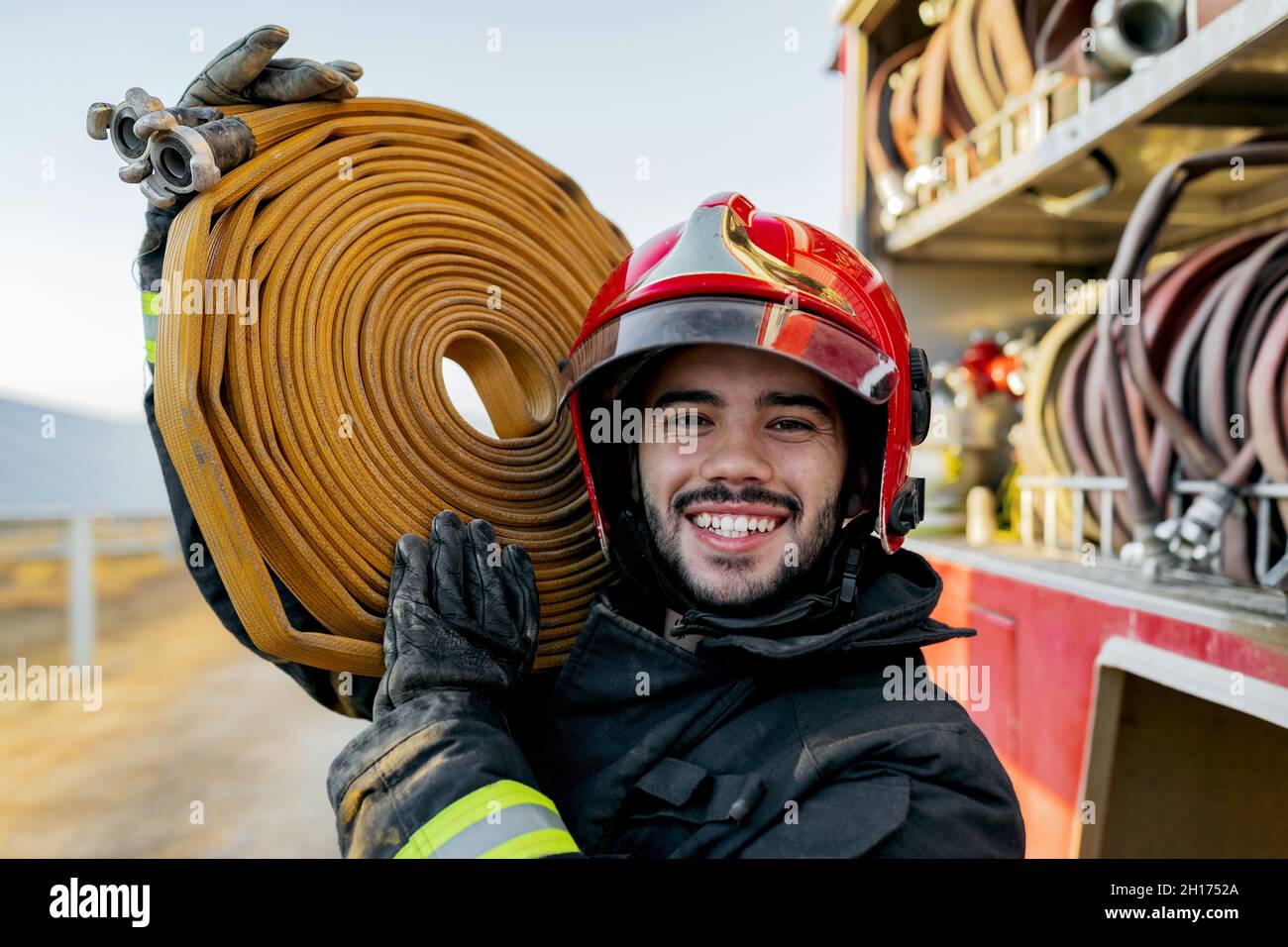 Firefighter carrying hose on shoulder hi-res stock photography and ...