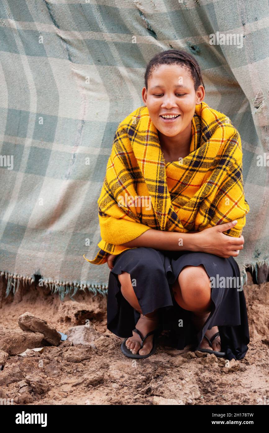 young basarwa covered with yellow blanket Stock Photo - Alamy