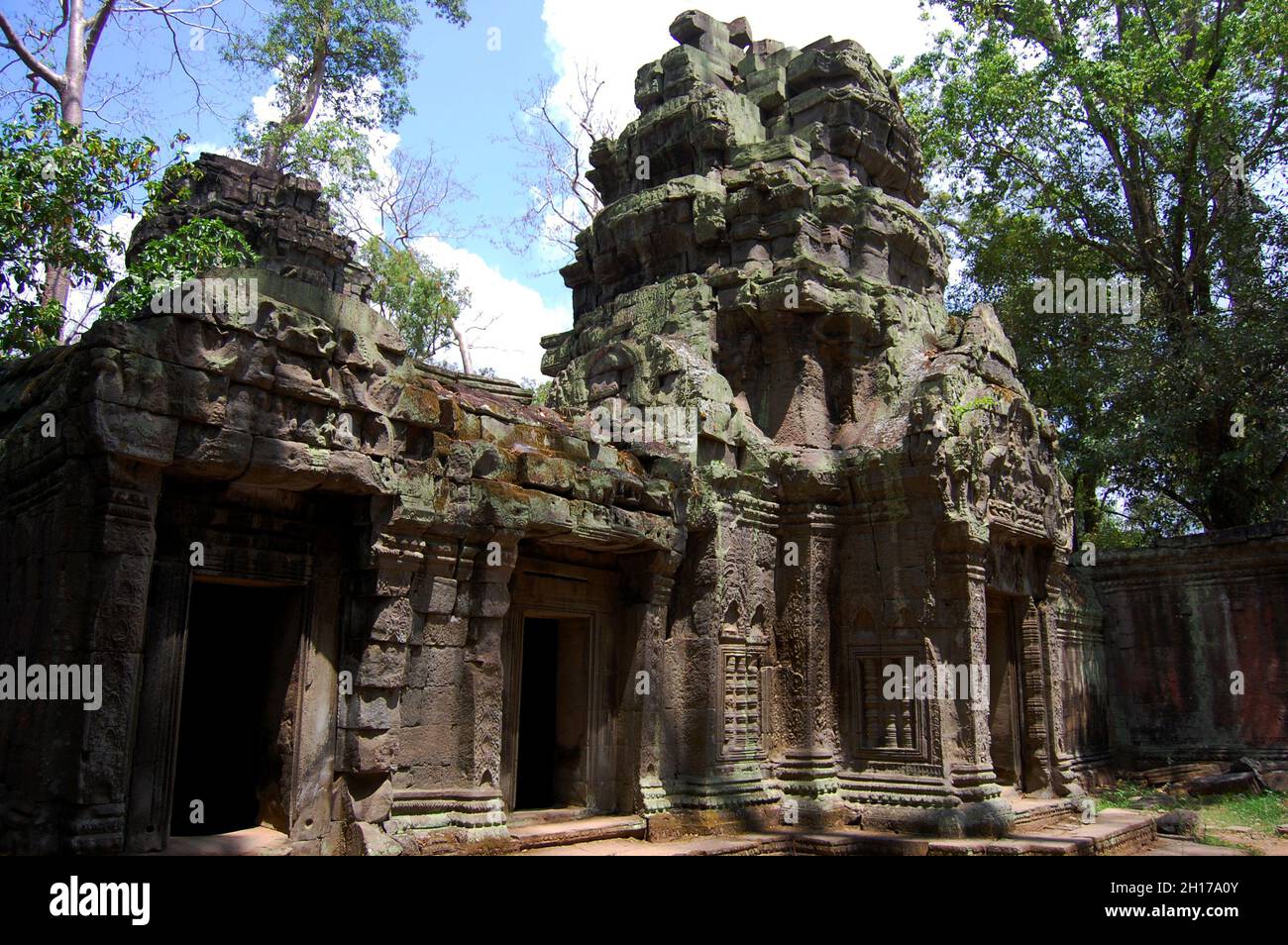 Tree roots and Ancient ruins antique building Prasat Ta Prohm or ...