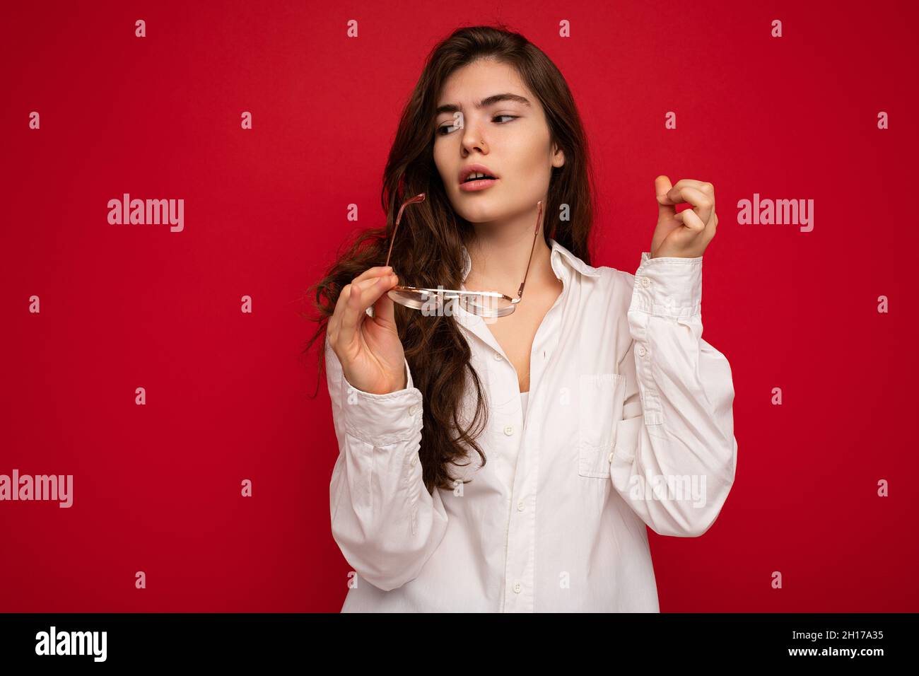Shot of attractive sorrowful sad upset young curly brunette woman ...