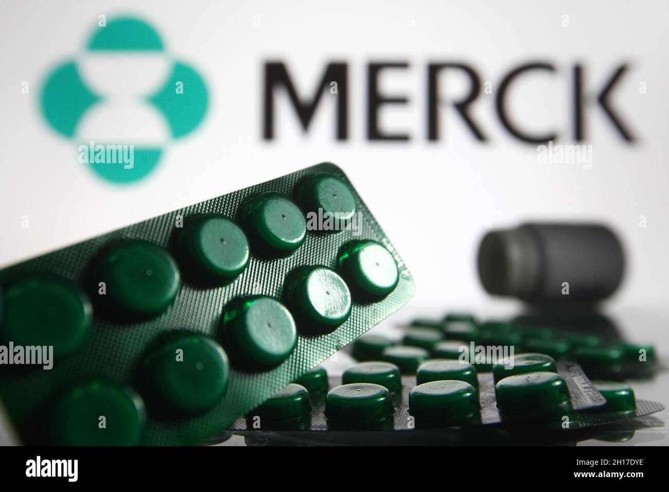 In this photo illustration, medicine pills are seen on display with a Merck & Co., Inc. logo of ...