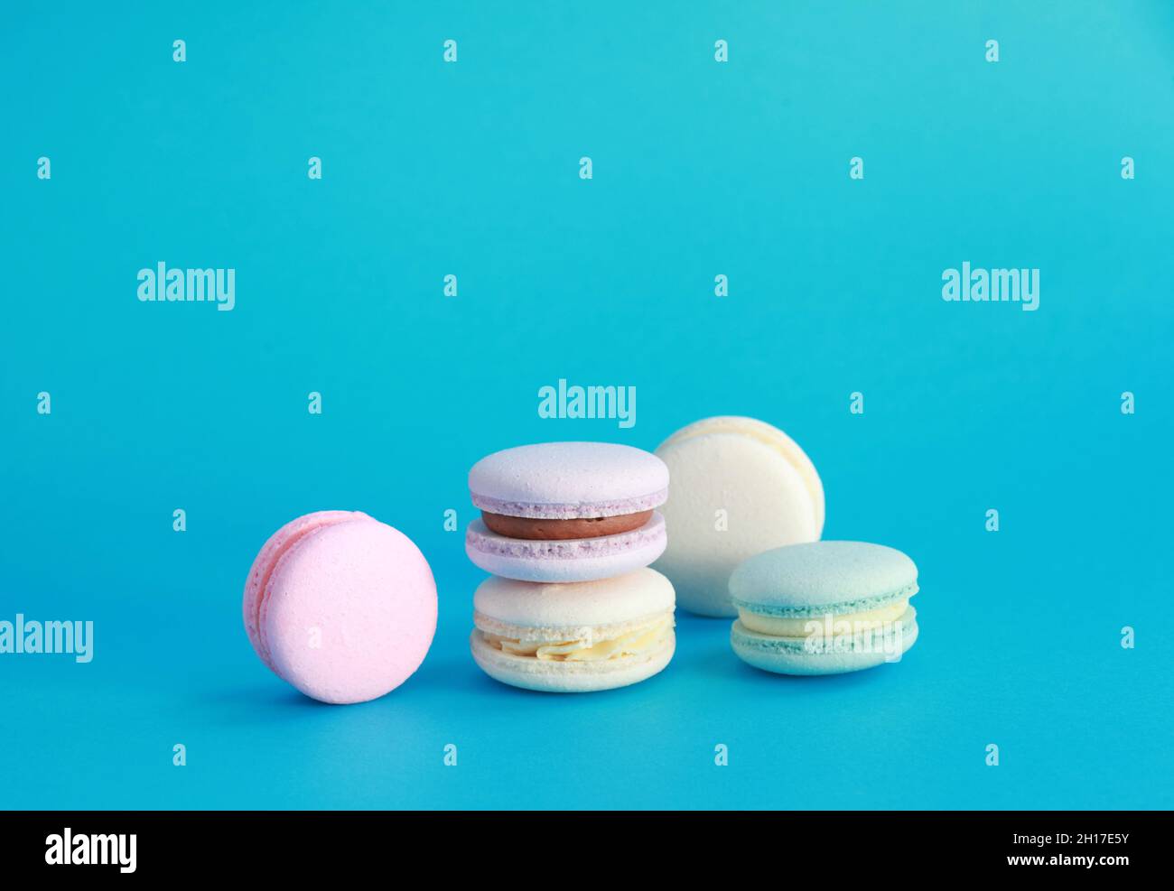 Macaron or macaroon on turquoise background, colorful almond cookies ...